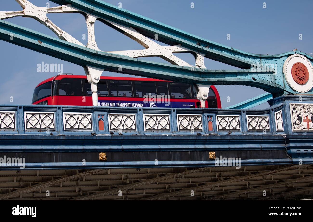 A red bus crossing Tower Bridge in London, UK Stock Photo - Alamy