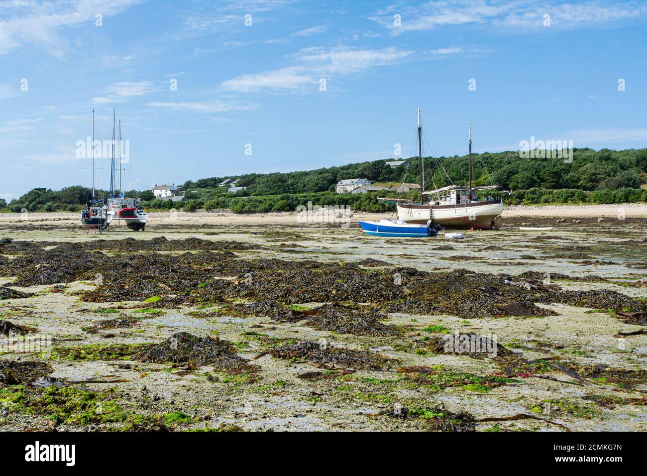 Boats stranded at extreme low tide in Green Bay, Bryher, Isles of ...