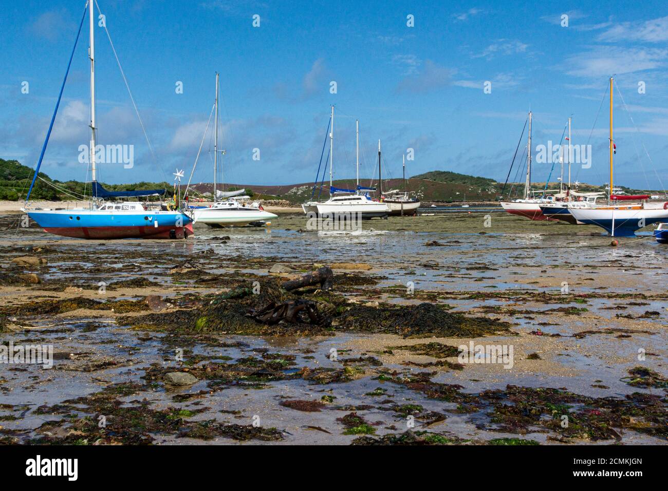 Boats stranded at extreme low tide in Green Bay, Bryher, Isles of ...