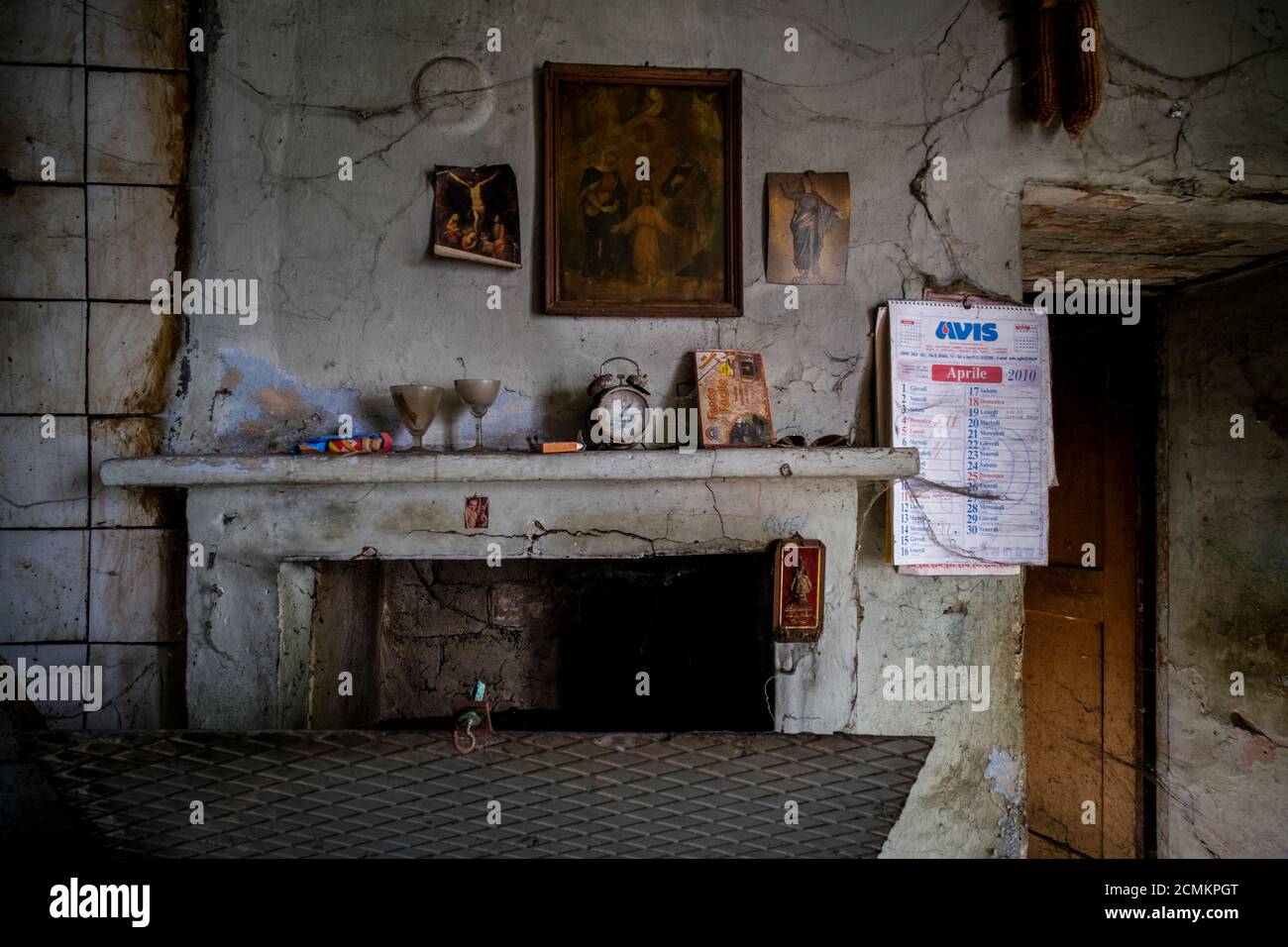 kitchen with table and dishes in abandoned old house with dust and ...