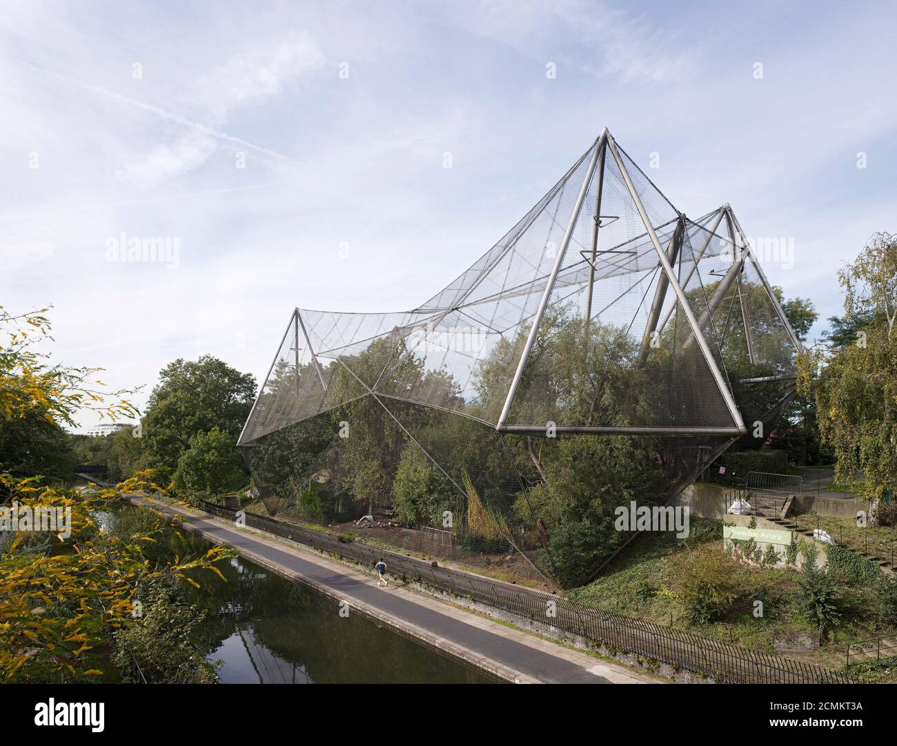 View towards aviary with Regent's Canal. Snowdon Aviary, London, United Kingdom. Architect ...