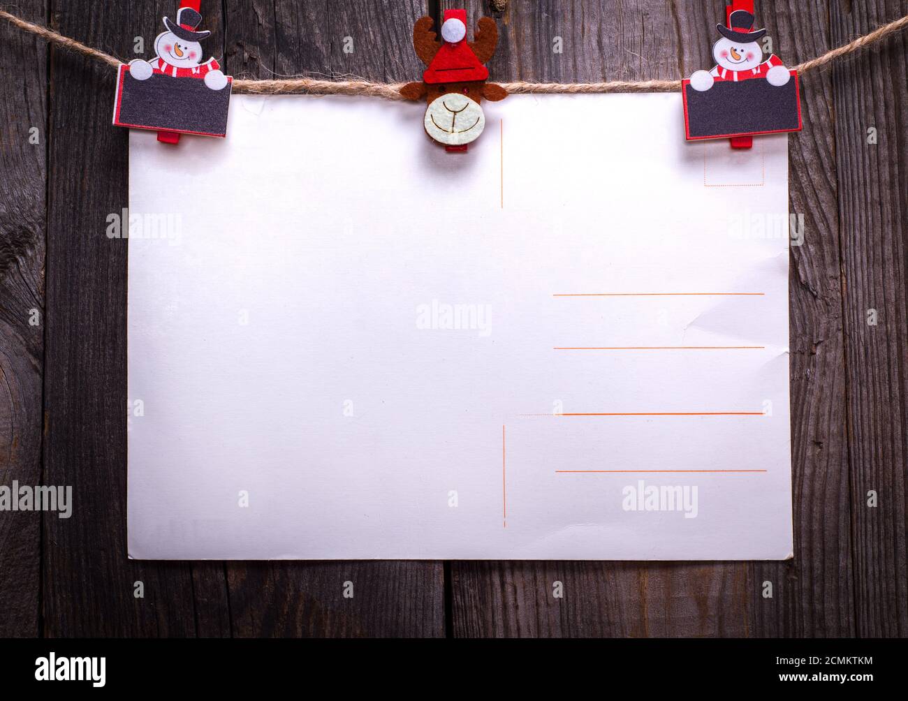 old paper postcard hanging on a rope Stock Photo - Alamy