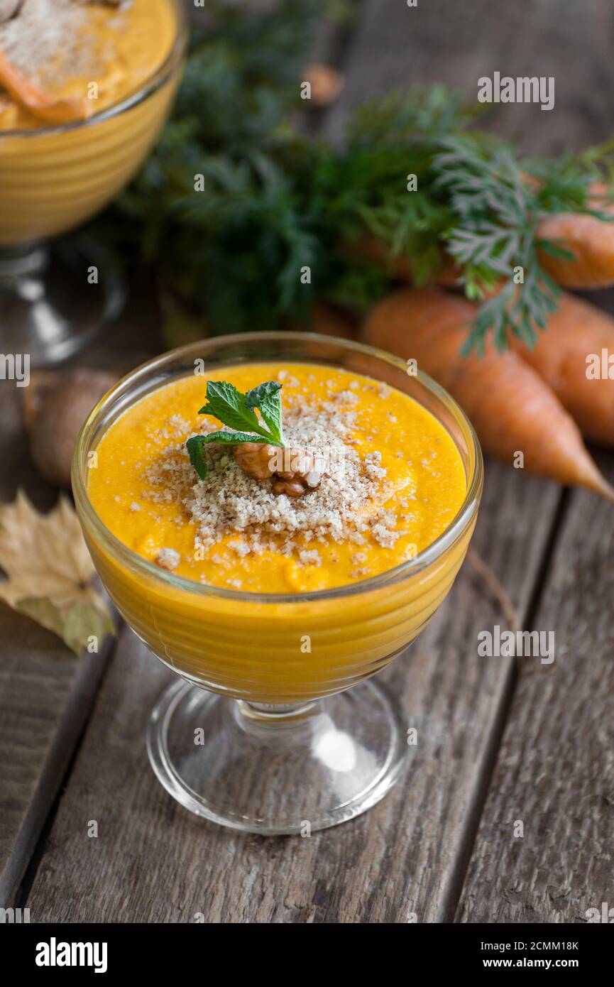 Carrot pudding with crushed walnut on an old wooden table Stock Photo ...