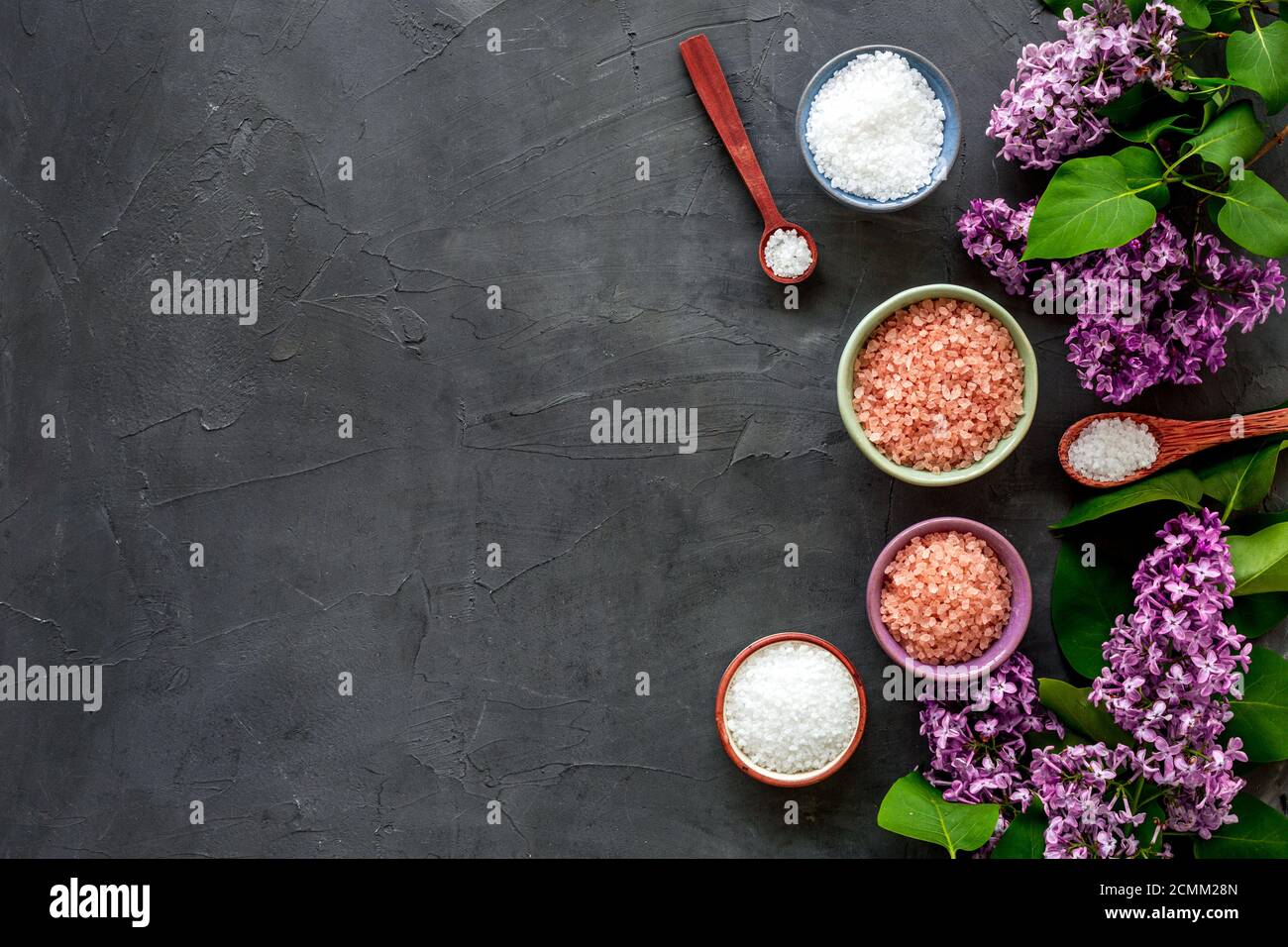 Sea salt spa set with pink lilac flowers. Top view Stock Photo - Alamy