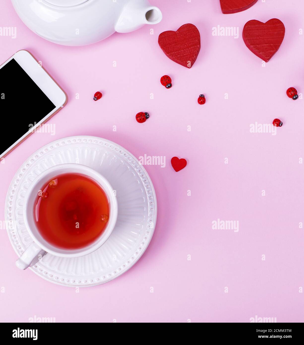 pink background with a cup of tea Stock Photo - Alamy