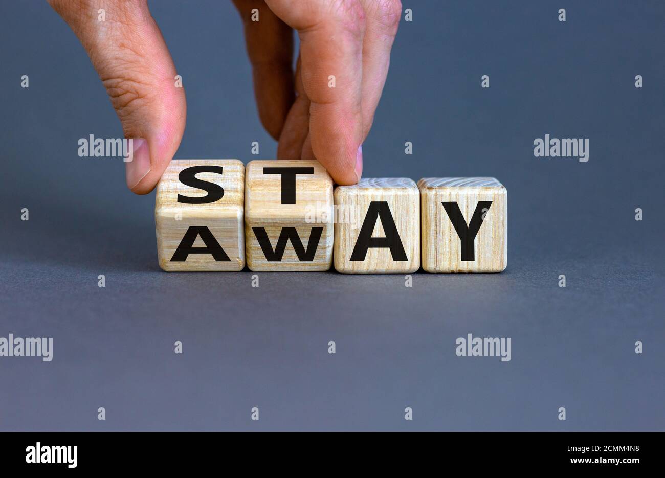 Hand turns a cube and changes the word 'away' to 'stay', or vice versa ...