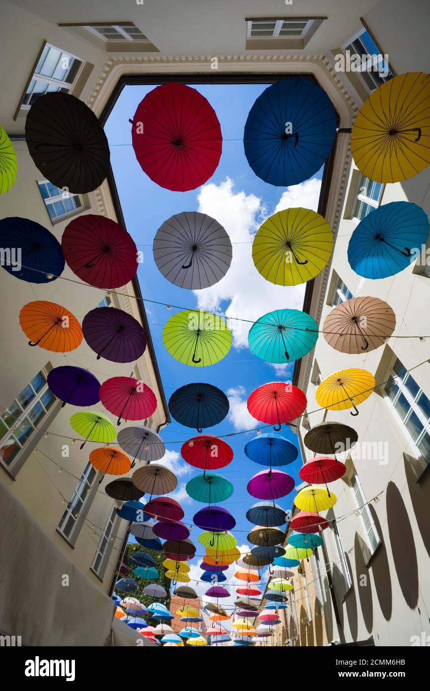 Colorful umbrellas hanging overhead in the inner yard of the old ...
