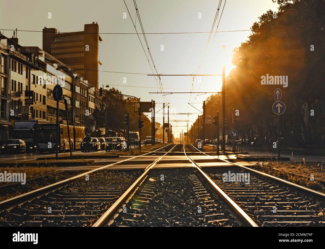 Railroad tracks and overhead lines of the city railroad in warm back ...