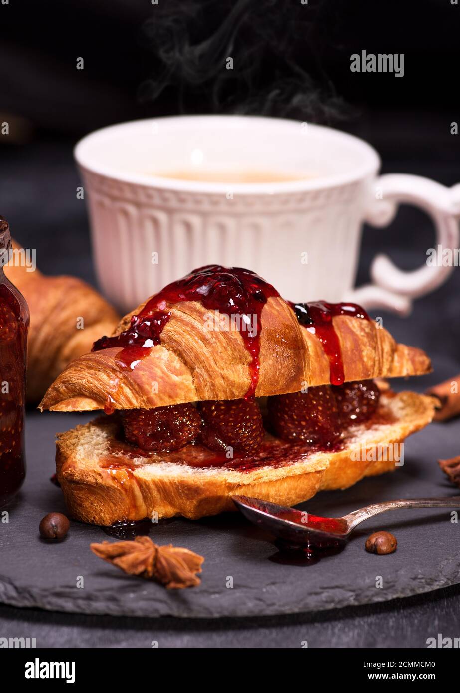 baked croissant with strawberry jam Stock Photo - Alamy