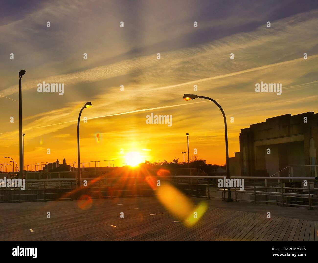 Orange Sunset Over Boardwalk, with Orange Sun just over Buildings. High ...