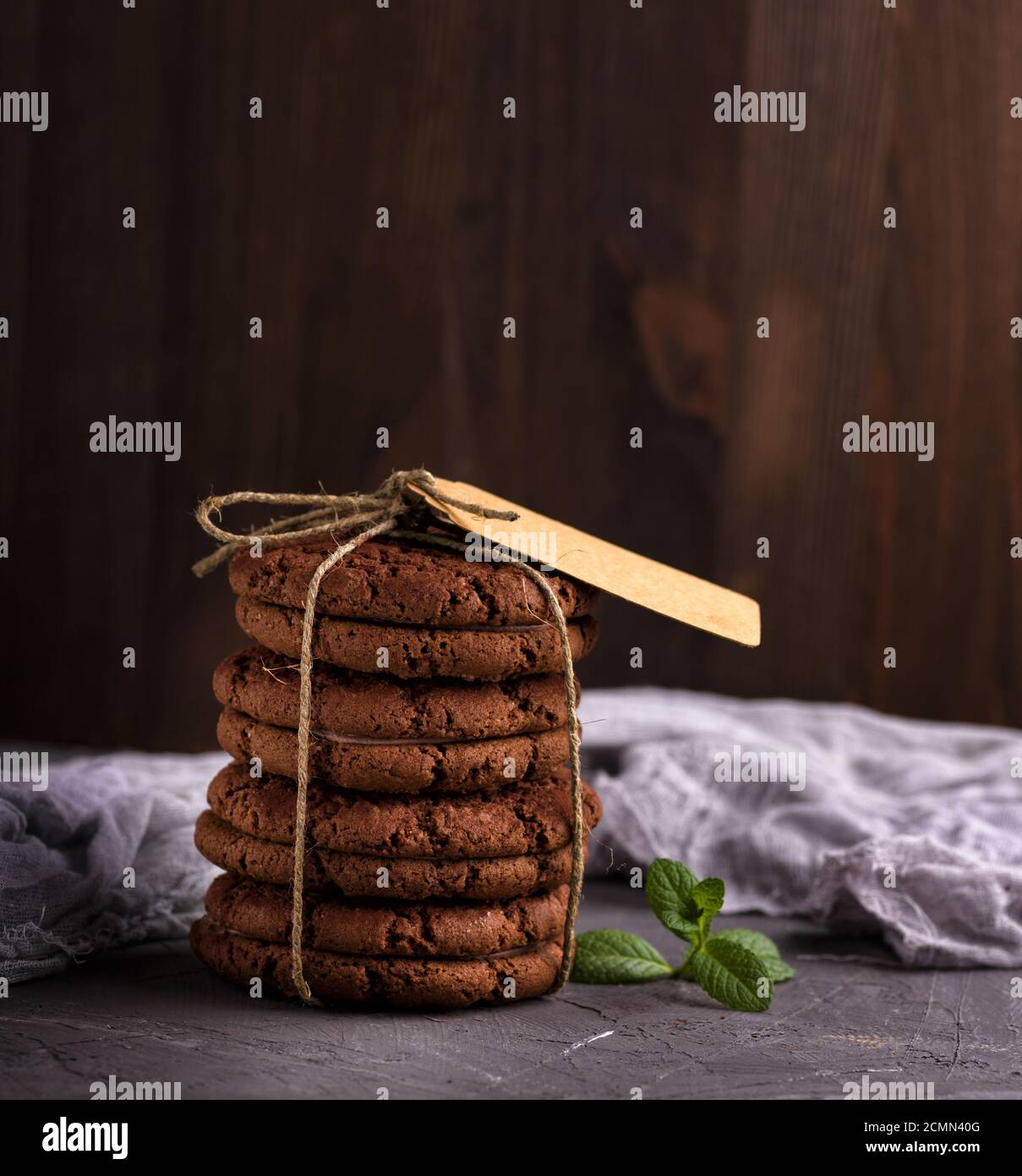 a stack of round chocolate cookies tied with a rope Stock Photo - Alamy