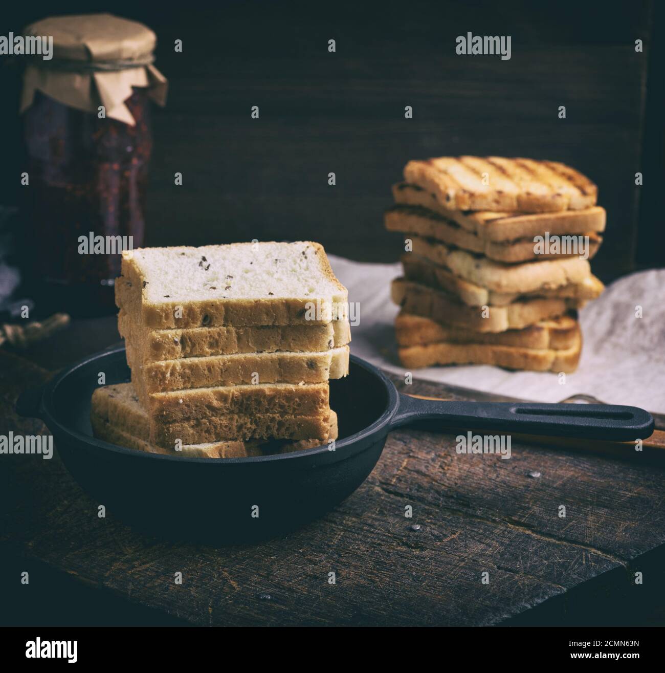 square pieces of white wheat flour in a black cast-iron frying pan ...