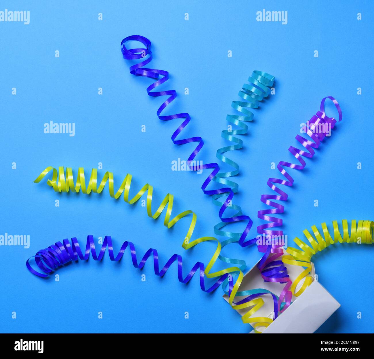 Multicolored paper serpentine shot from a white paper box Stock Photo ...