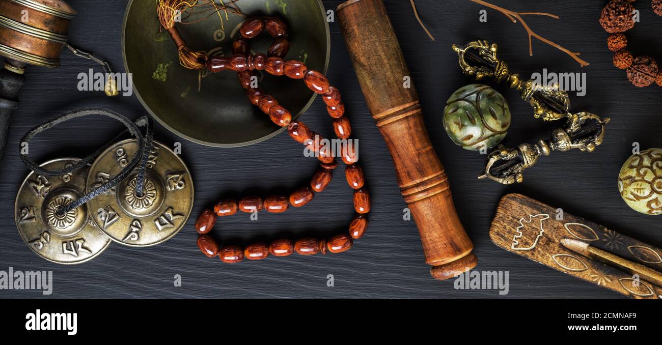 Copper singing bowl, prayer beads, prayer drum, stone balls and other ...