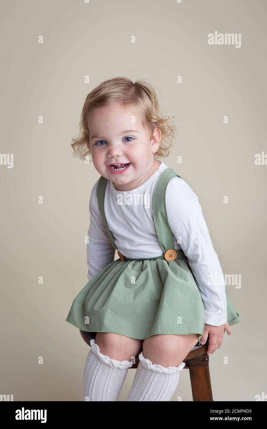 Girl sitting on stool hi-res stock photography and images - Alamy