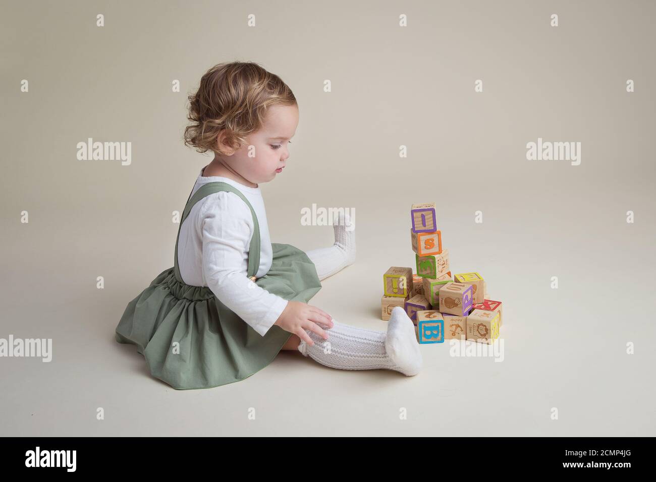 Toddler Girl Playing with Blocks Stock Photo - Alamy