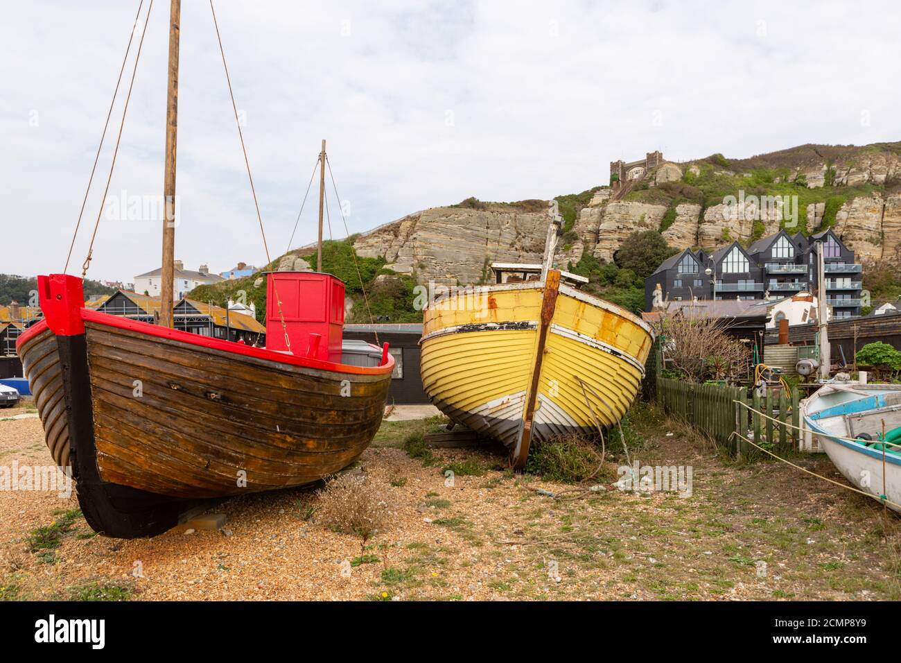 Fishing boats on Hastings beach with a view toward The East Hill lift ...