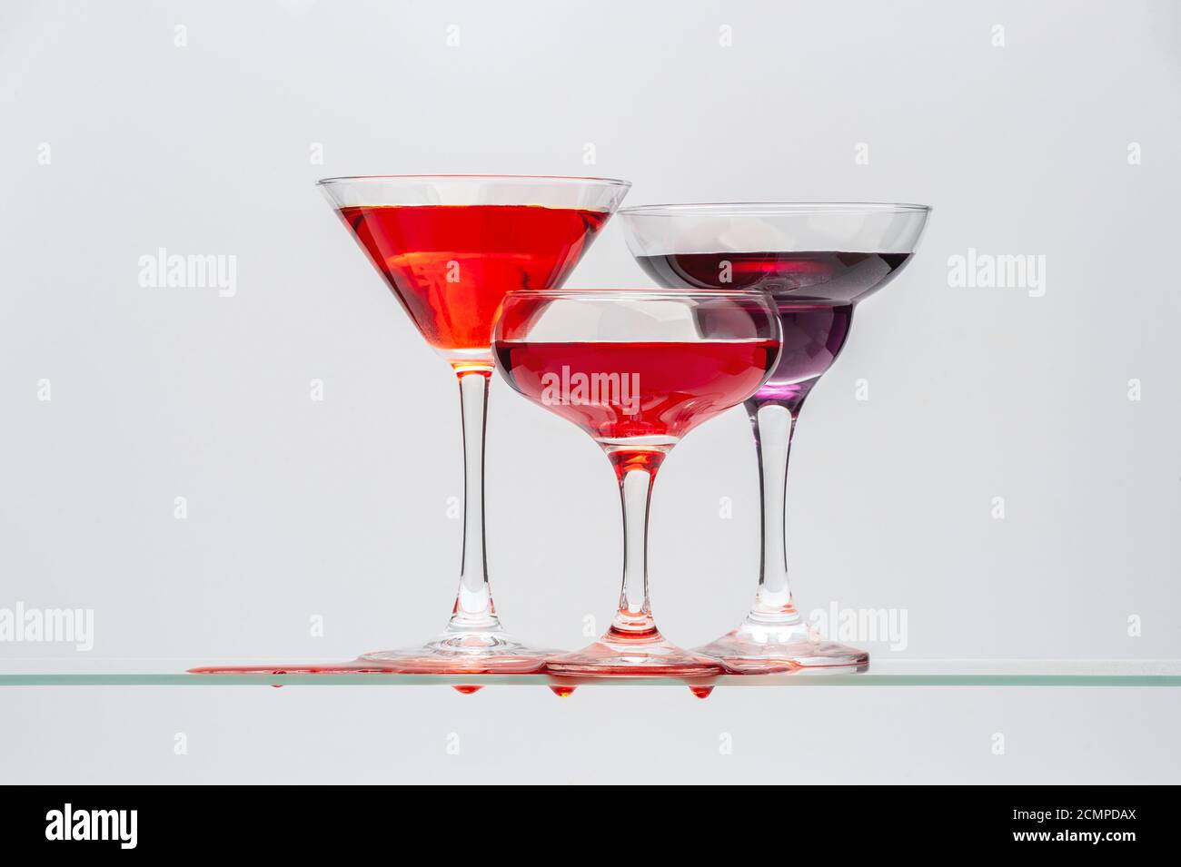 Three glasses with different drinks Stock Photo - Alamy