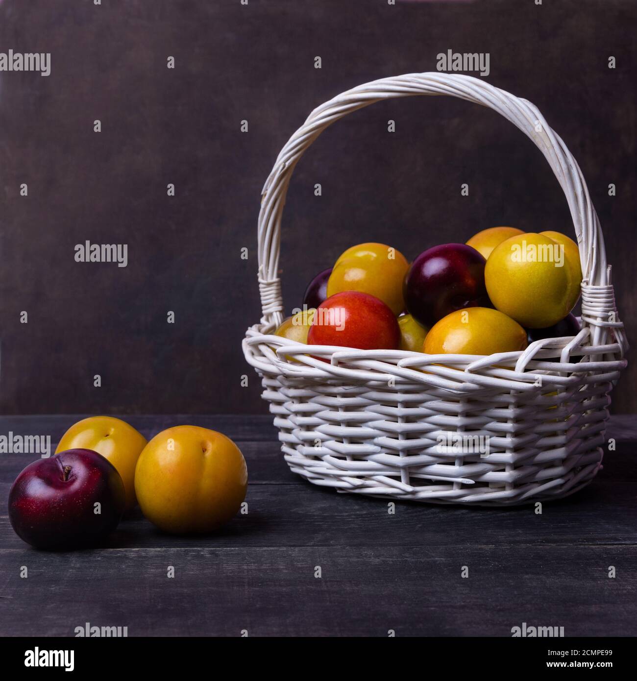 Colorful plums fruit in basket on the black background isolated Stock ...