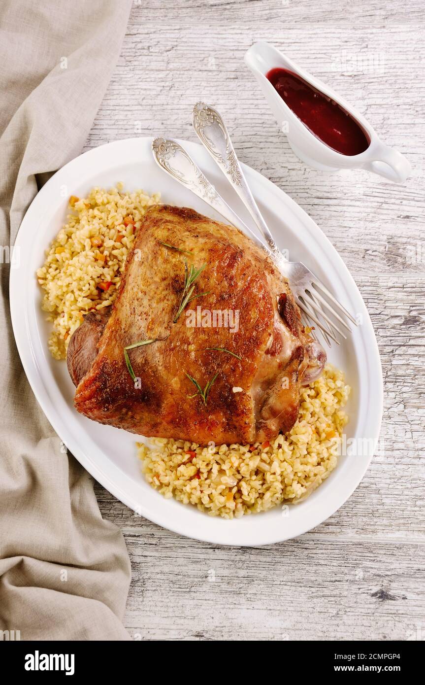Baked turkey thigh with garnish bulgur and vegetables Stock Photo - Alamy
