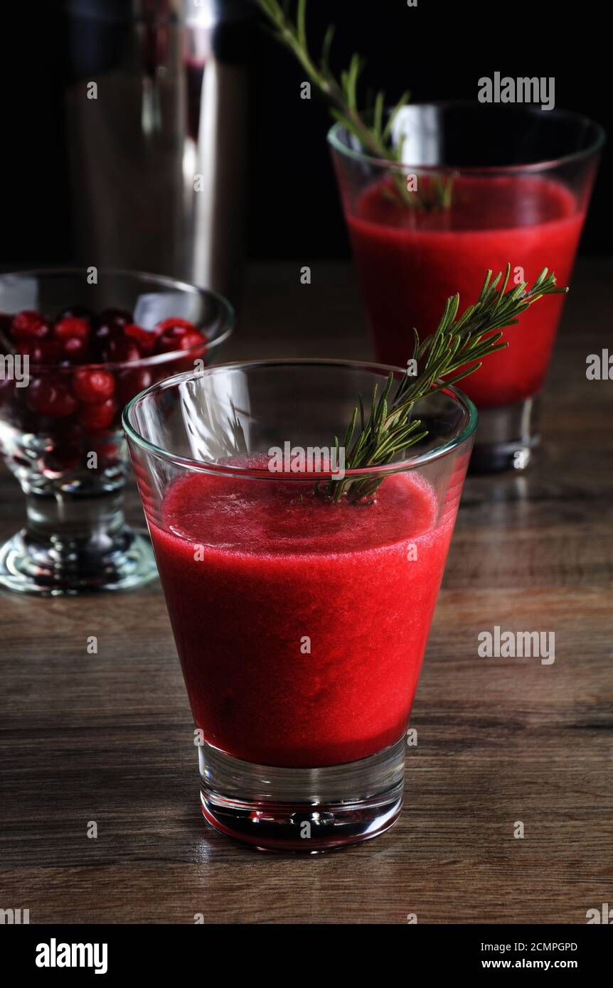 Freshly made cranberry juice with a sprig of rosemary Stock Photo - Alamy