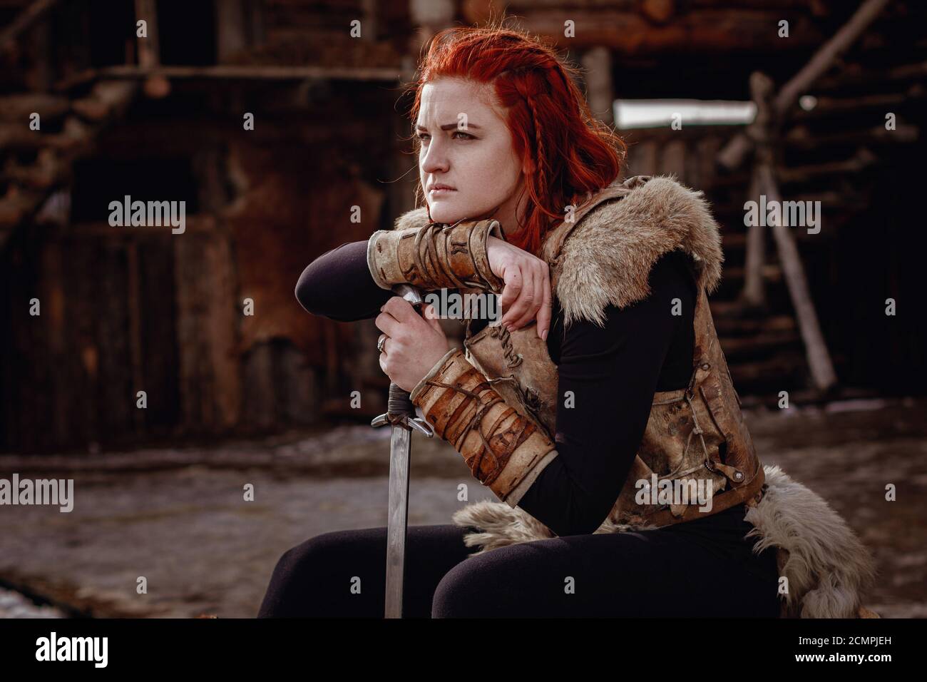 Viking girl with red hair. In the hands of the sword to fight the enemy ...