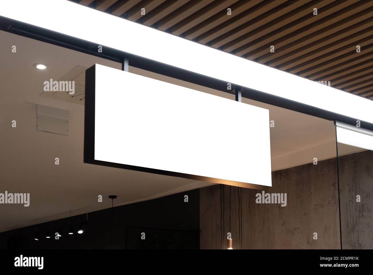 Mock up. Horizontal white empty signage on store shop front inside ...