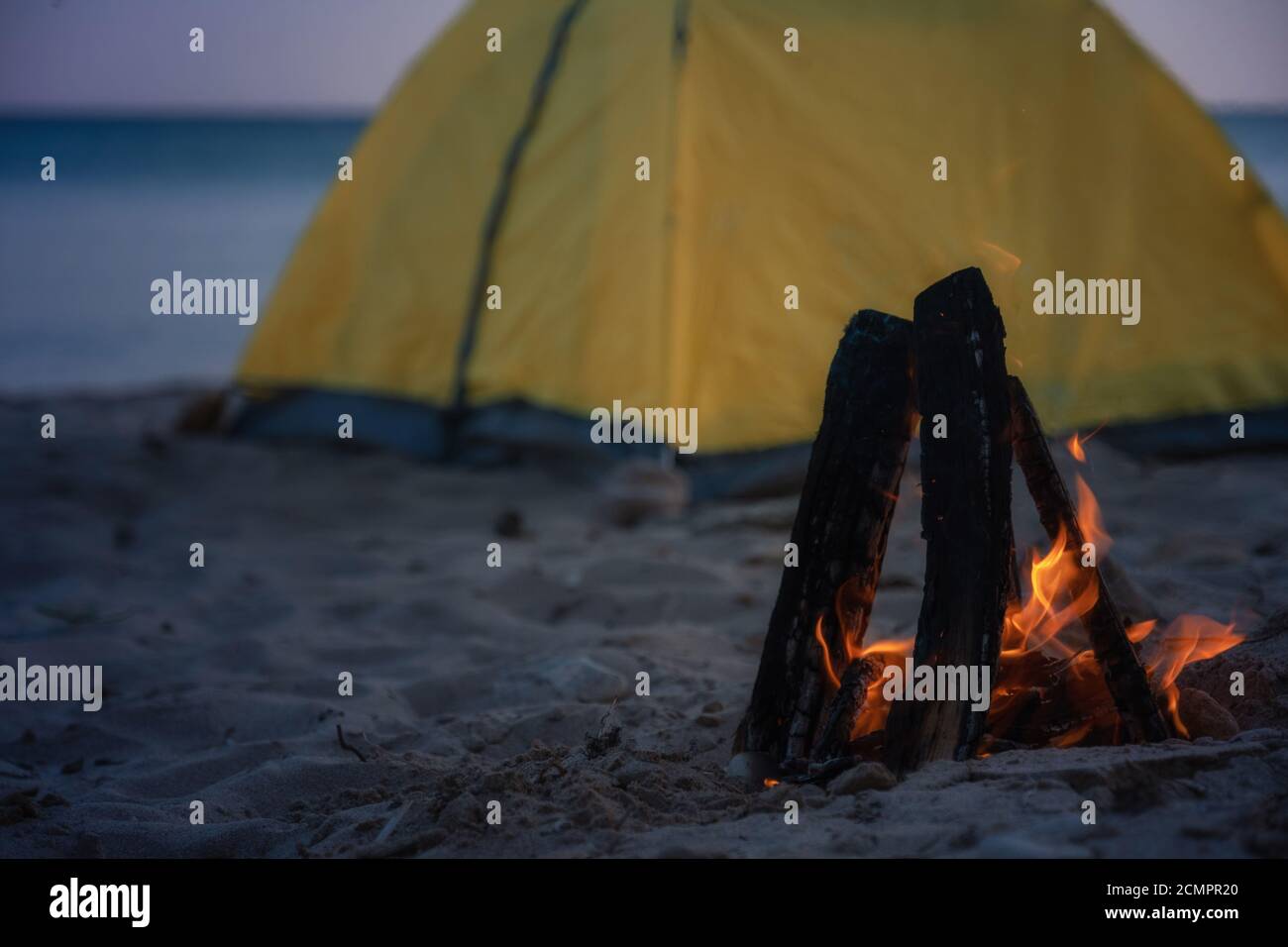Closeup Fire in bonfire in the beach . Camping and tents to travel ...