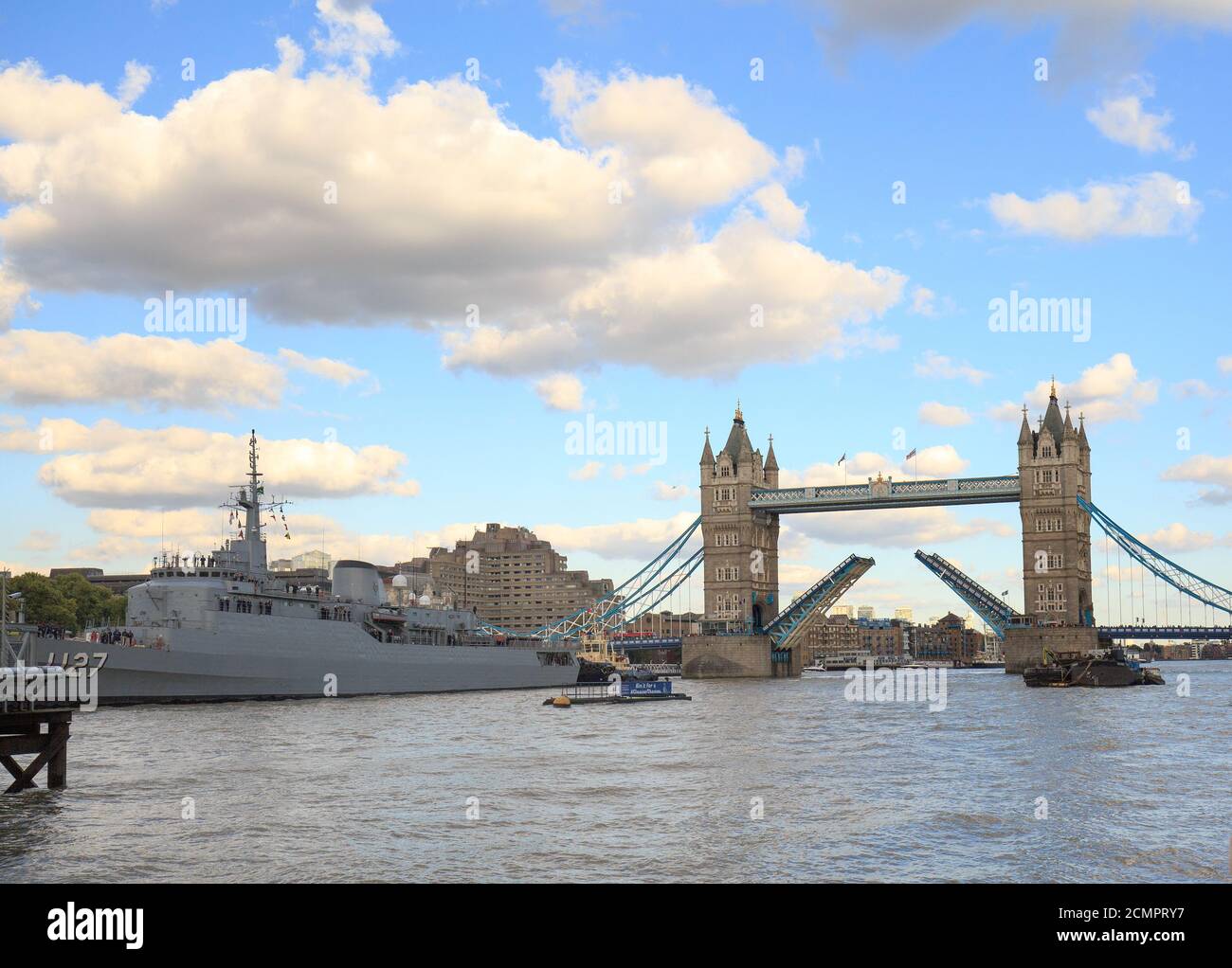 Tower Bridge opening to allow a large ship to pass through, London ...