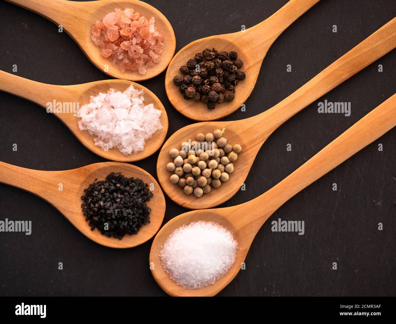 Wooden spoons with himalayan salt, black hawaii salt, common salt, salt ...
