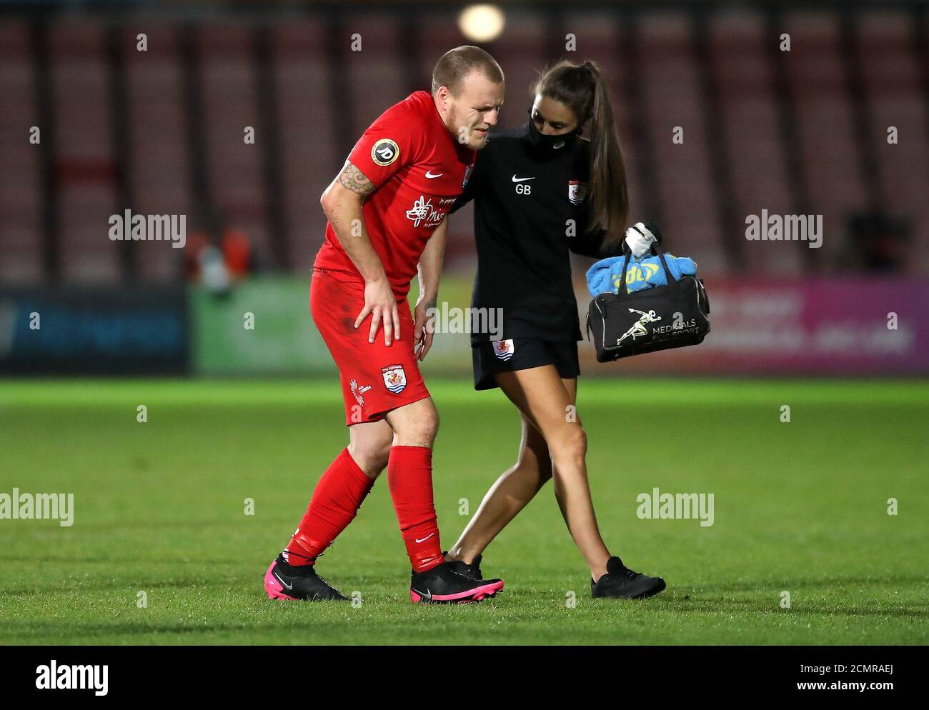 Connah's Quay Nomads' Jamie Insall (left) is helped off the pitch with ...