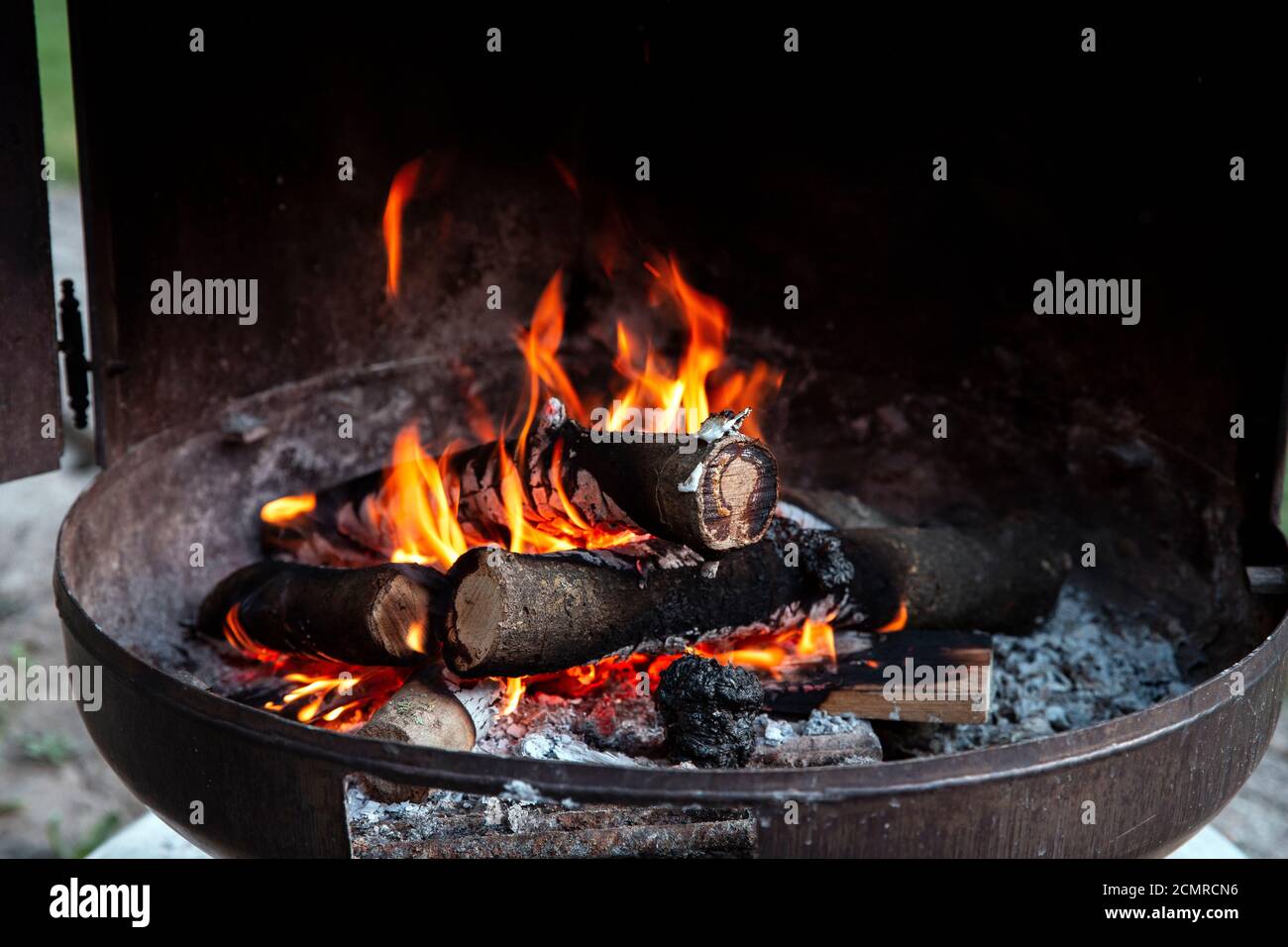 Campfire in metal container, fire ring closeup of burning logs and ...