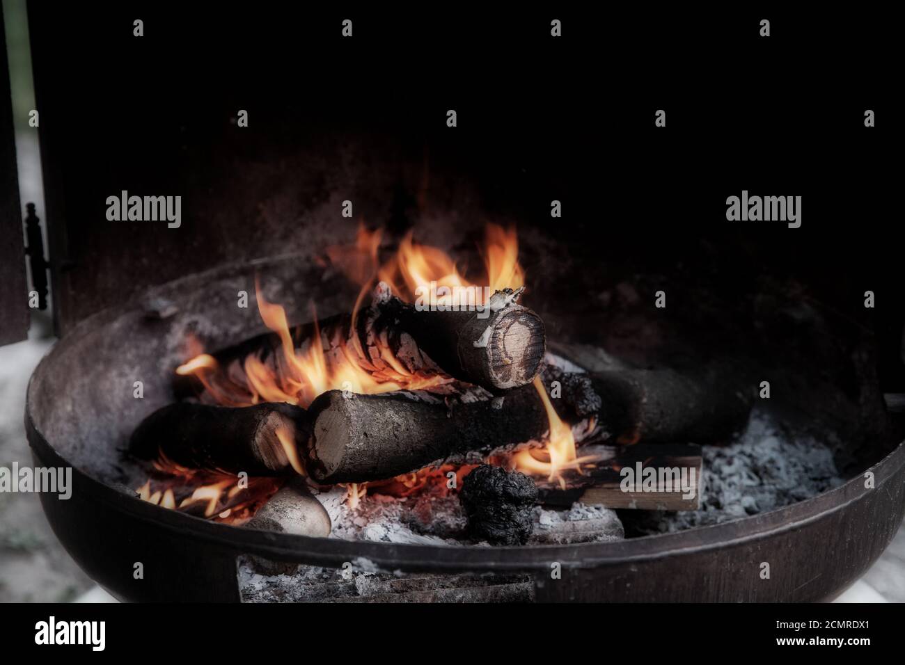 Campfire in metal container, fire ring closeup of burning logs and ...