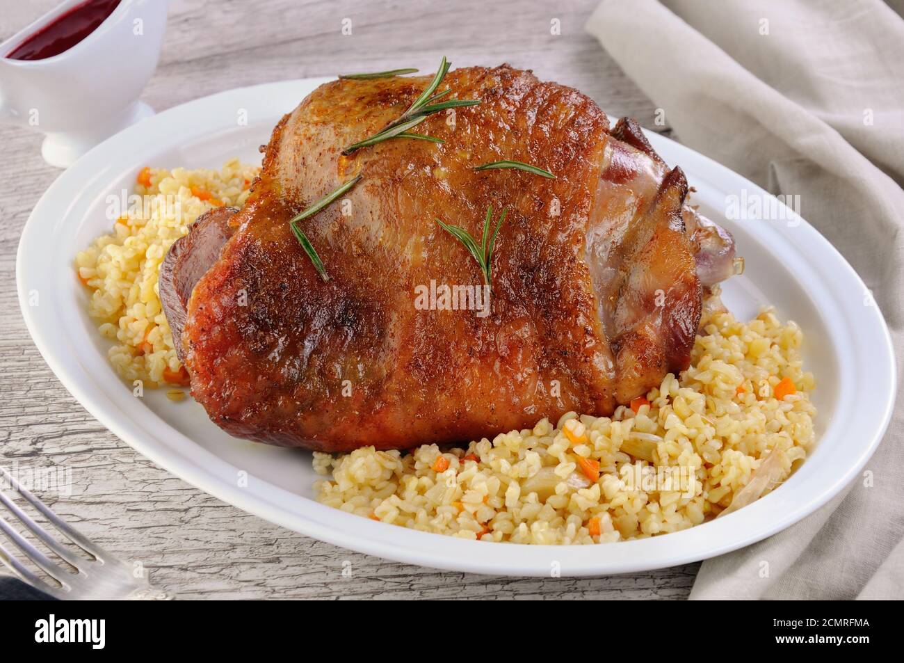 Baked turkey thigh with garnish bulgur and vegetables Stock Photo - Alamy