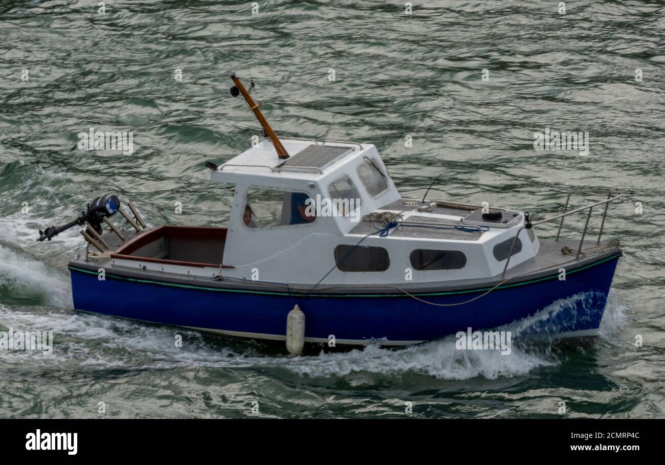 a small day angling or fishing boat like a hardy or colvic underway in ...