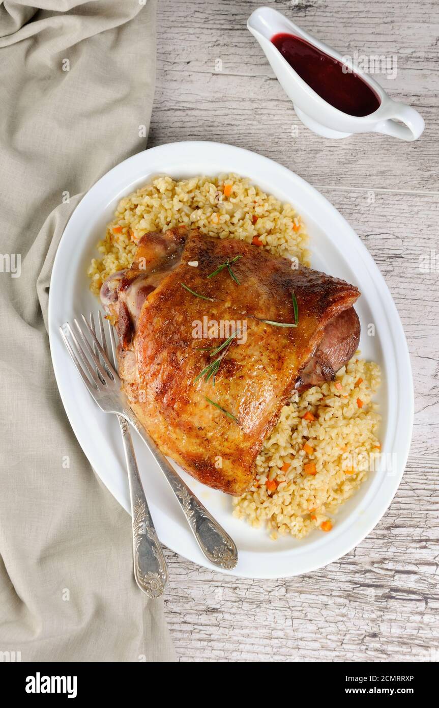 Baked turkey thigh with garnish bulgur and vegetables Stock Photo - Alamy