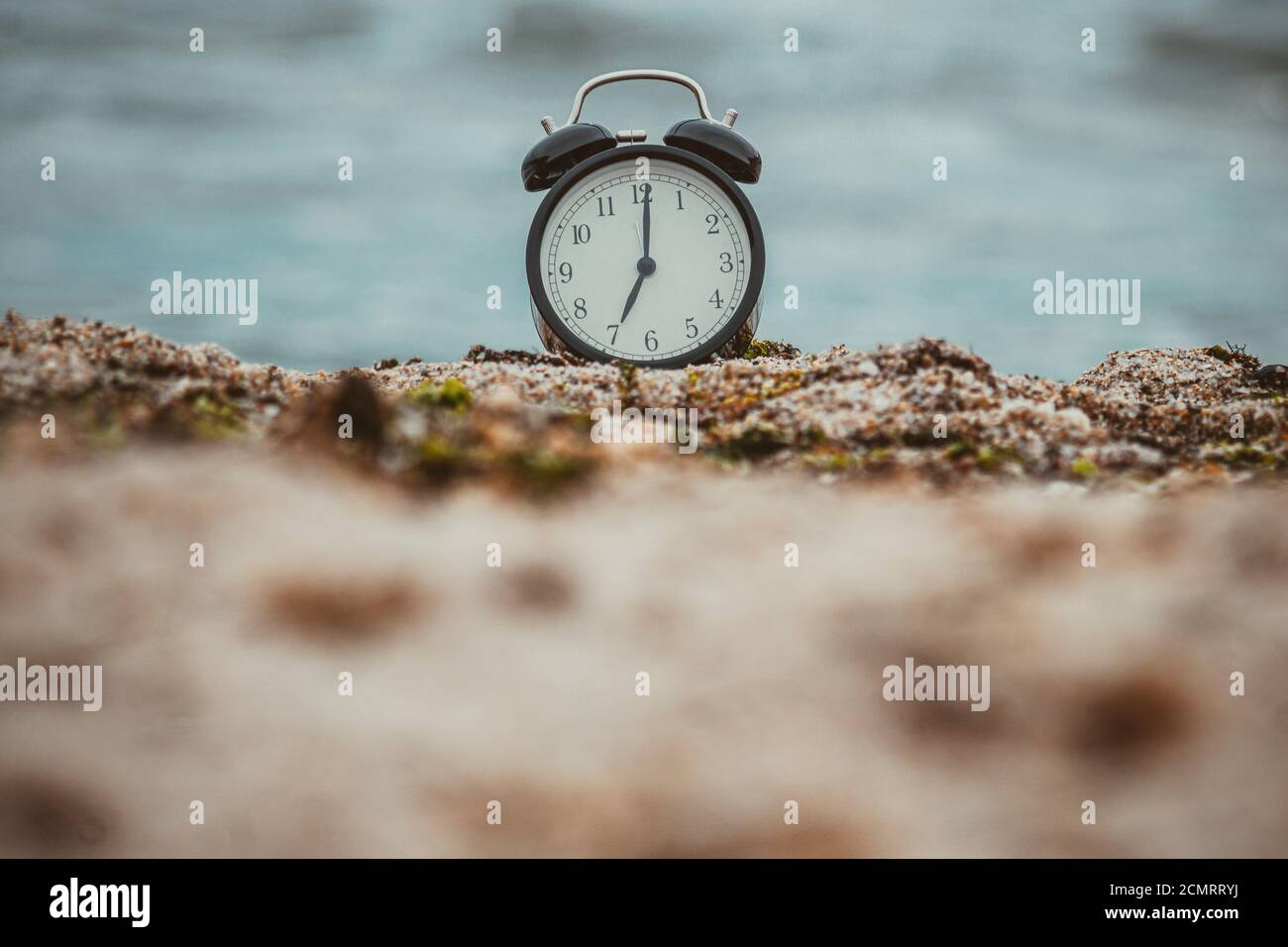 ALARM CLOCK AT THE BEACH WITH TRENDING COLORS. CONCEPT OF SUMMER ENDING ...