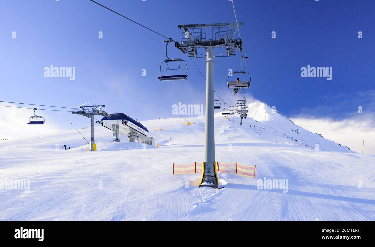 Snowy ski slopes and chair ski lifts station in mountain ski resort ...
