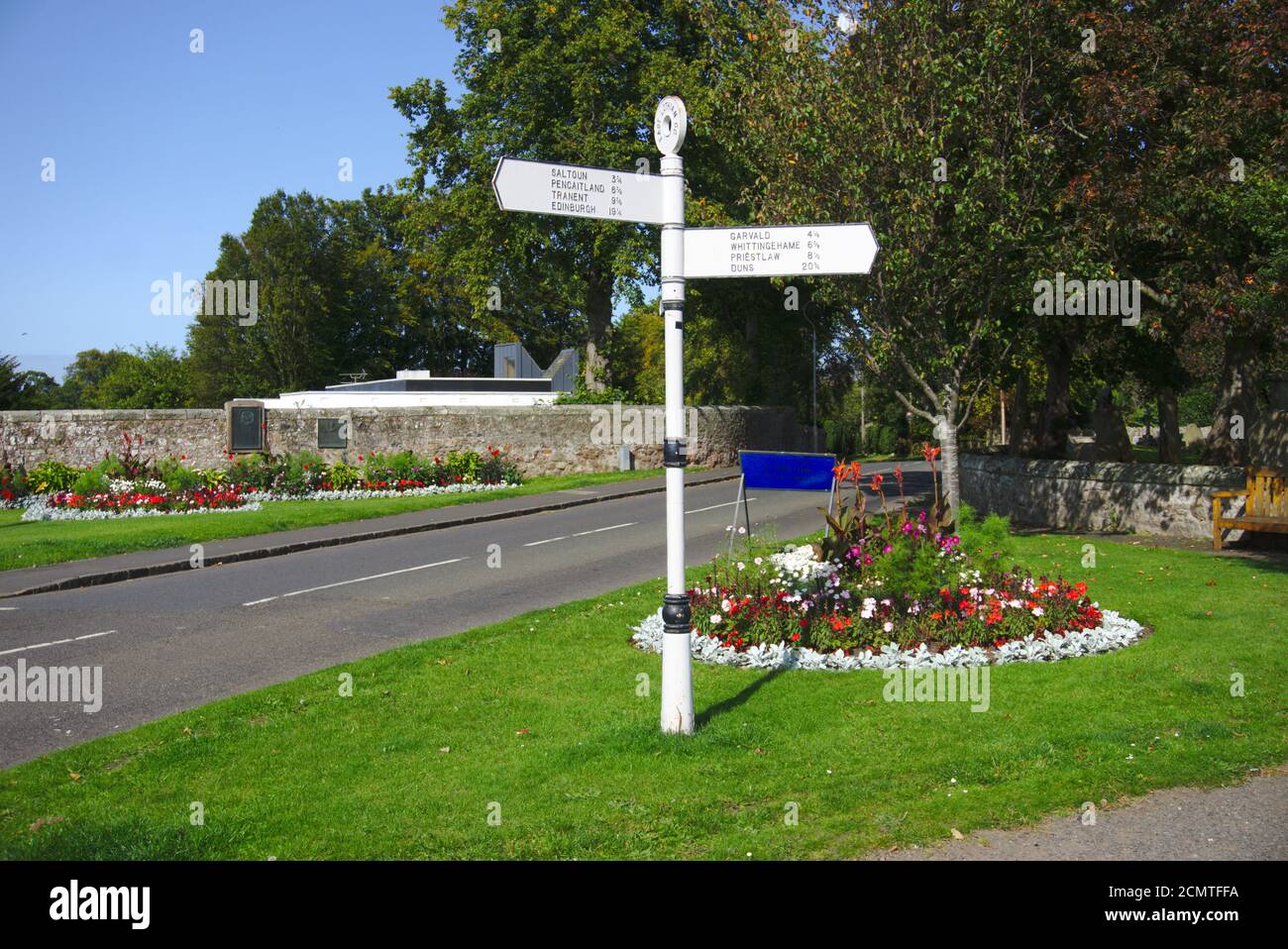 Signpost and floral arrangements pictured on a warm later summer ...
