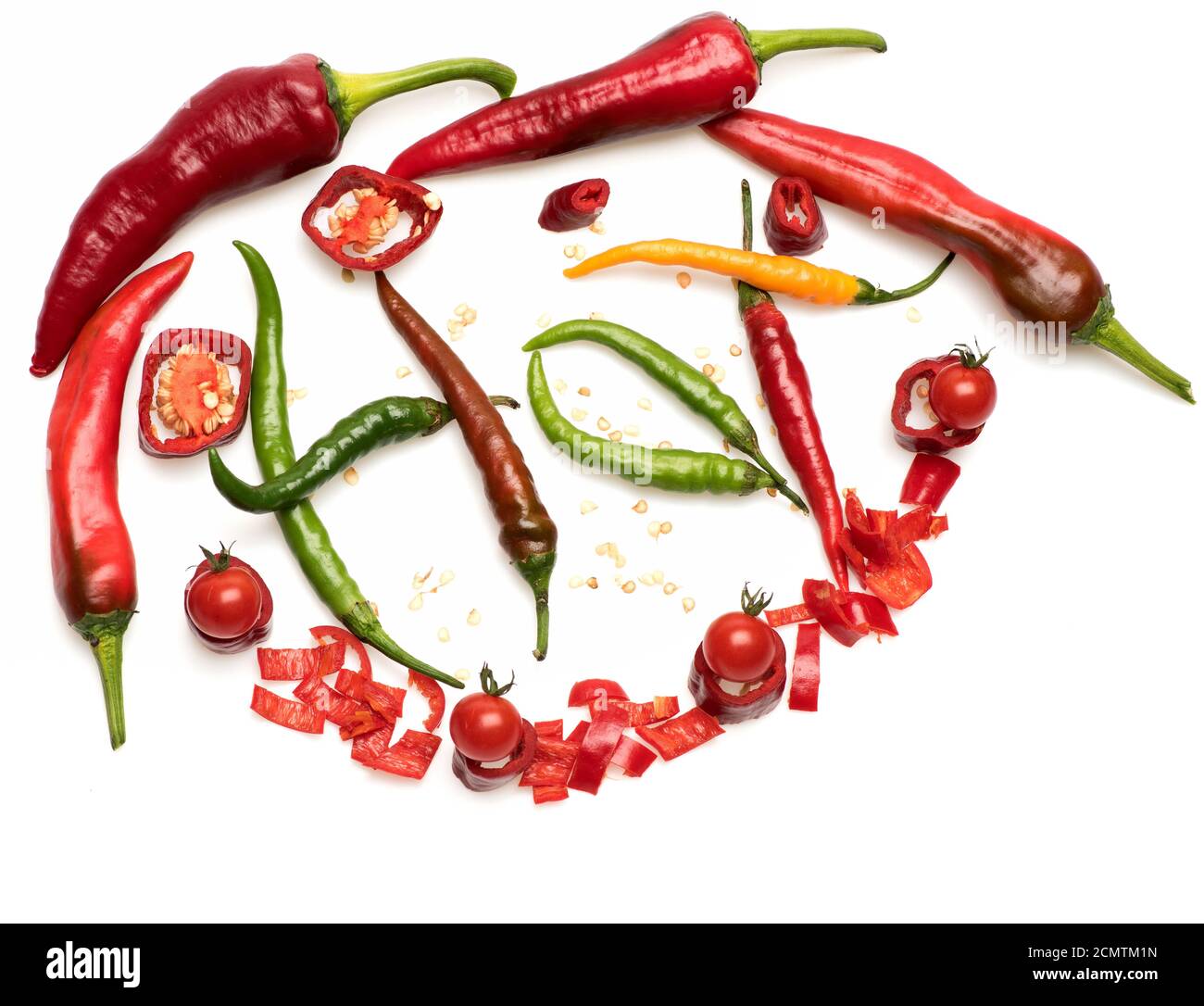 Chopped chili peppers in red color around sign. Cut red hot pepper bits ...
