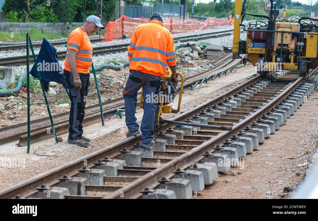 Railway workers bolting track rail Stock Photo - Alamy