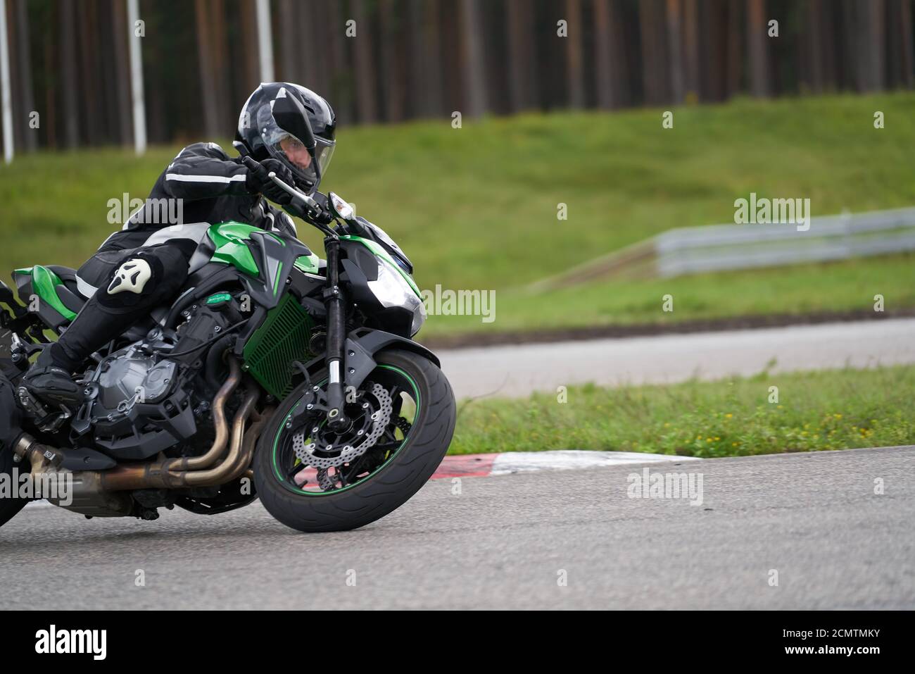 Handsome motorcyclist in black riding his super sport motorcycle Stock ...