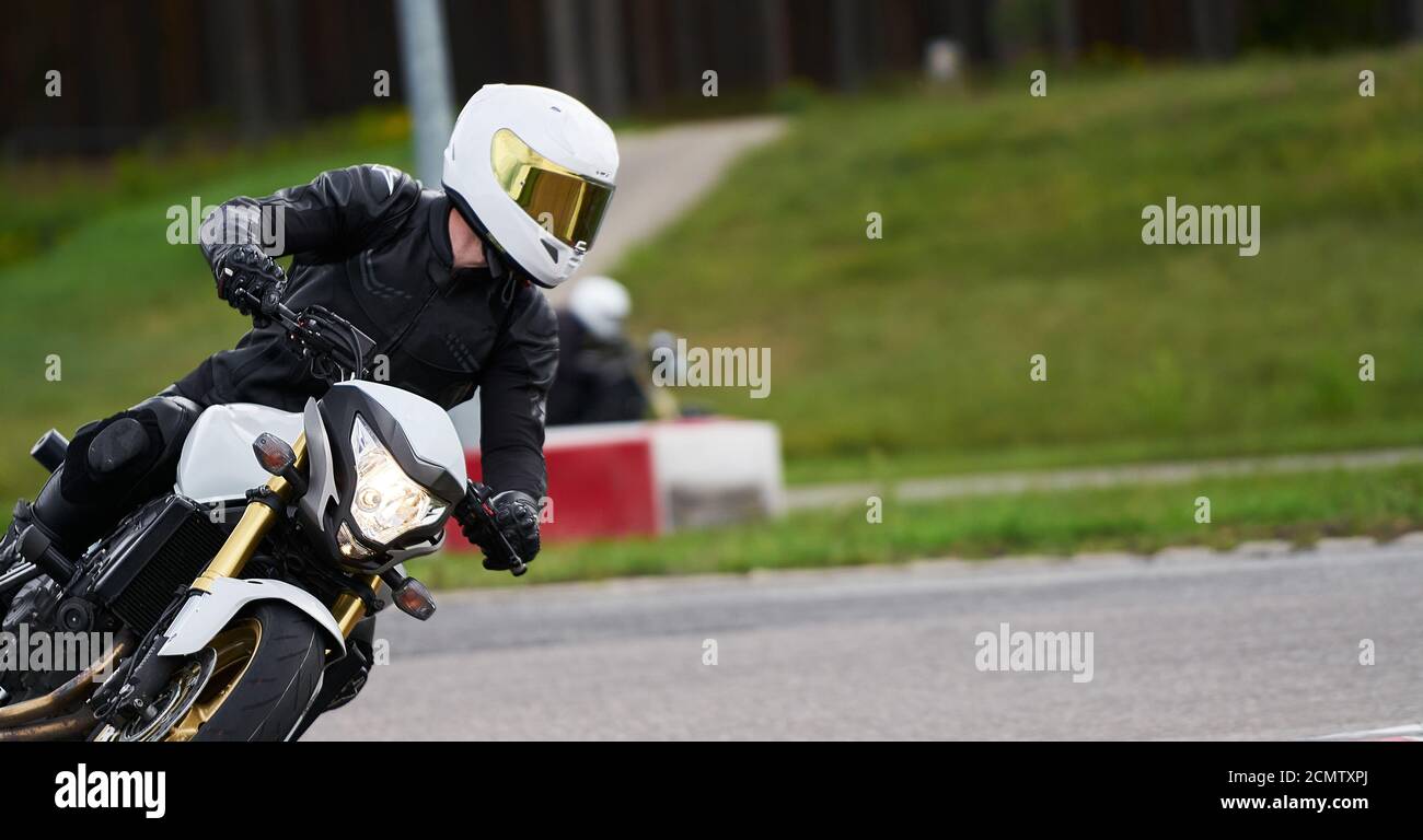 Handsome motorcyclist in black riding his super sport motorcycle Stock ...