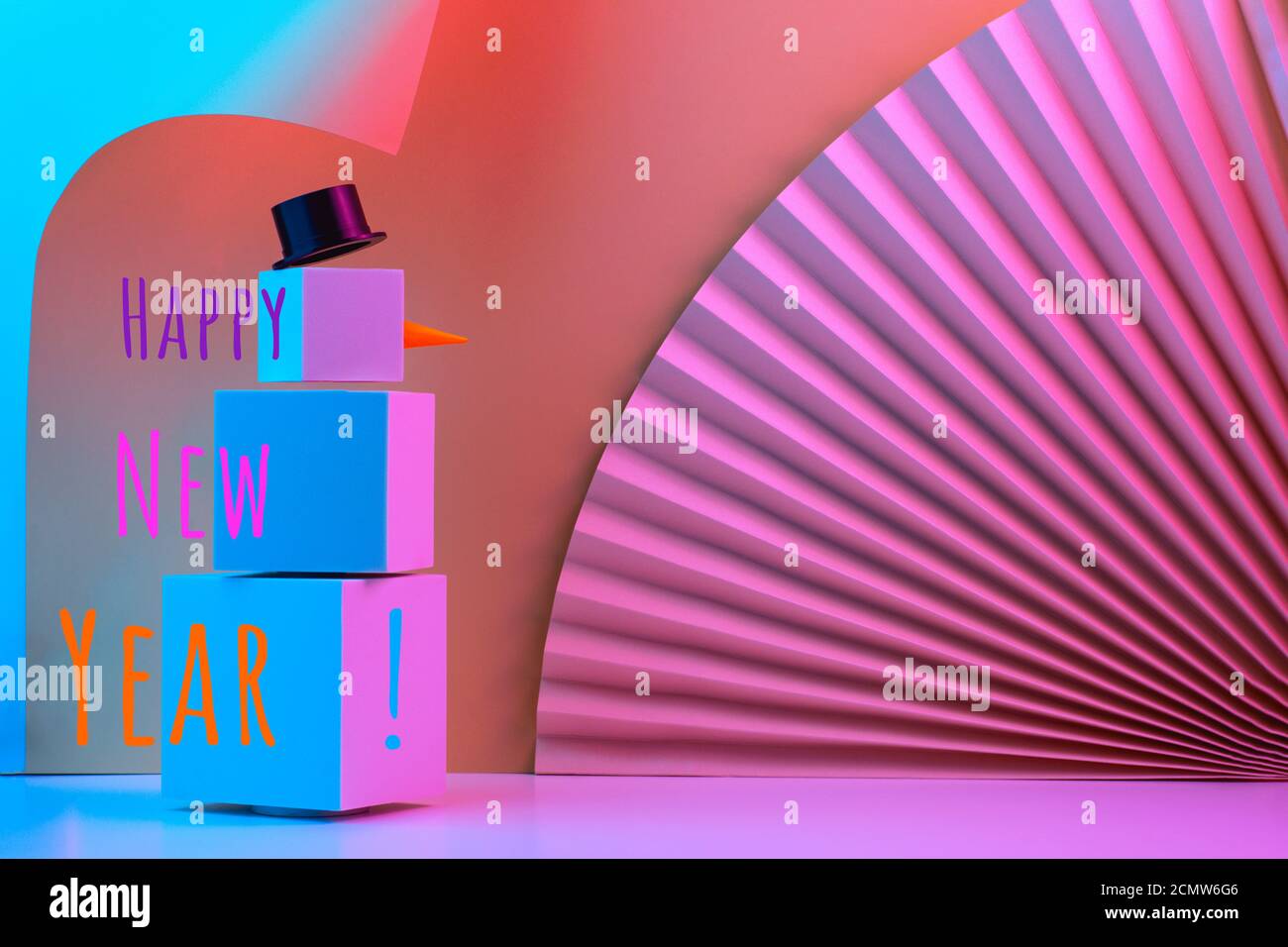 The polygonal snowman of cubes is illuminated with neon light, against ...