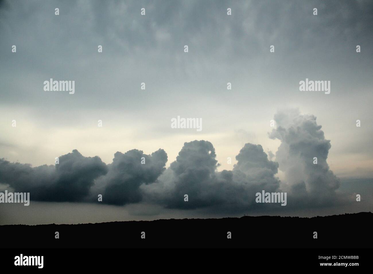 Pillars of storm clouds building up in a gloomy sky Stock Photo - Alamy