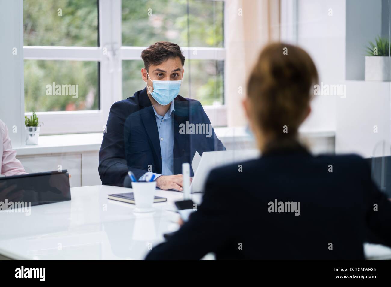 Person in office wearing mask hi-res stock photography and images - Alamy