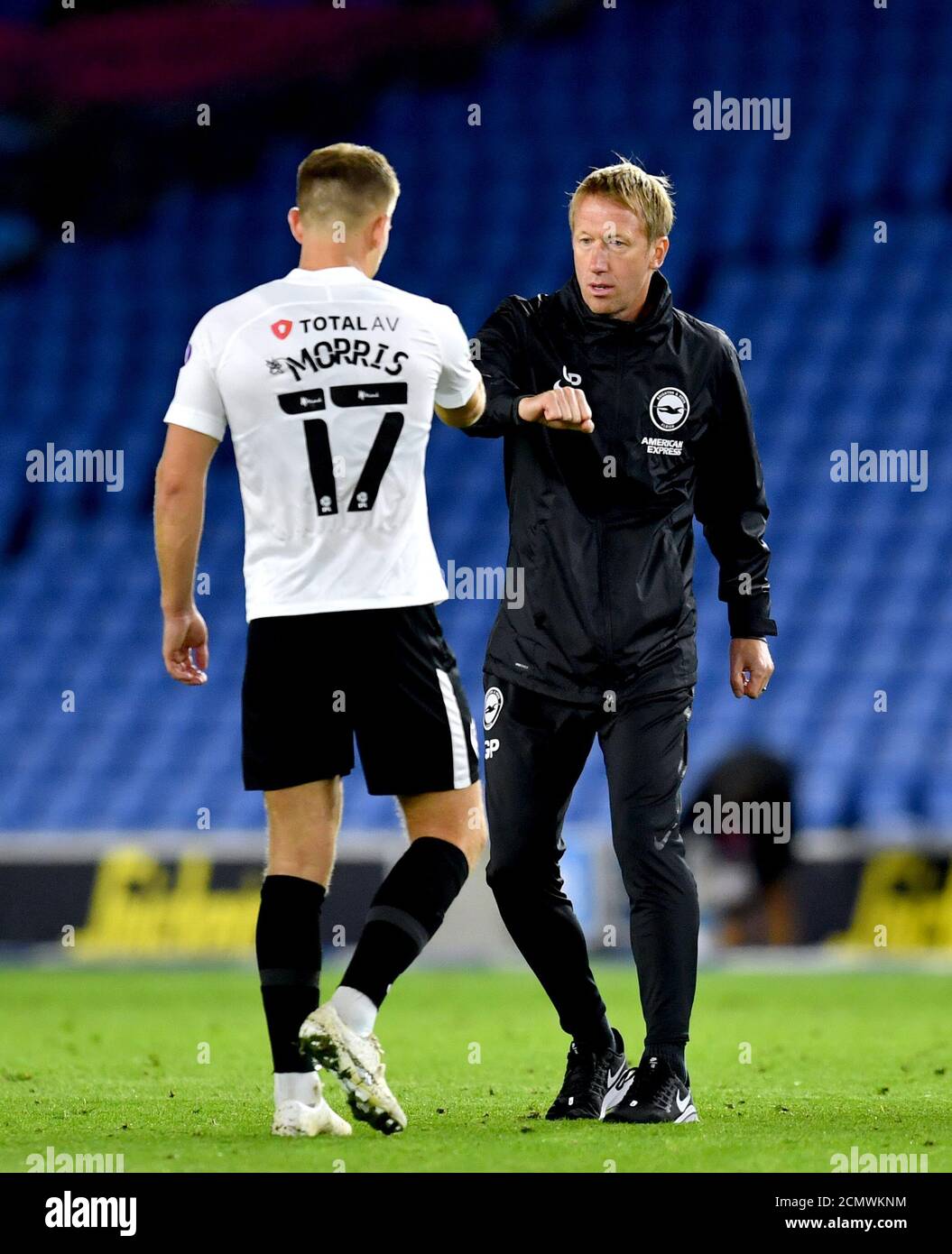 Brighton and Hove Albion manager Graham Potter (right) bumps elbows ...