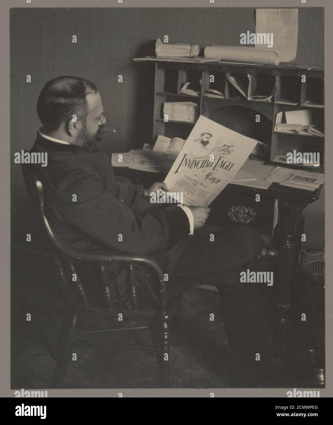John Philip Sousa seated at a desk and looking at ‘The Invincible Eagle ...