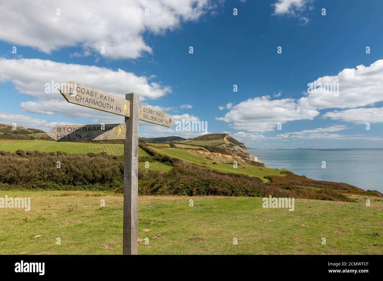 Close up of a sign post pointing toward Golden Cap mountain with Golden ...