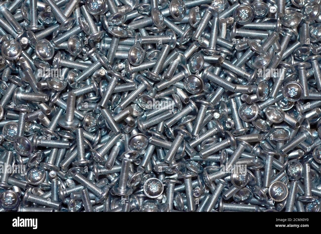 Many screws to fasten materials as a background Stock Photo - Alamy